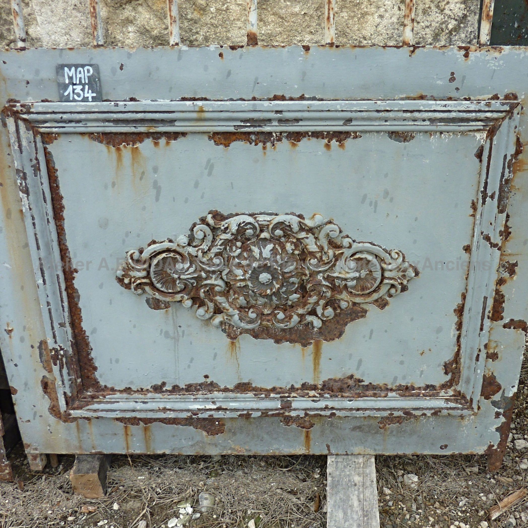 Antique riveted wrought-iron gate with two semi-openwork doors.