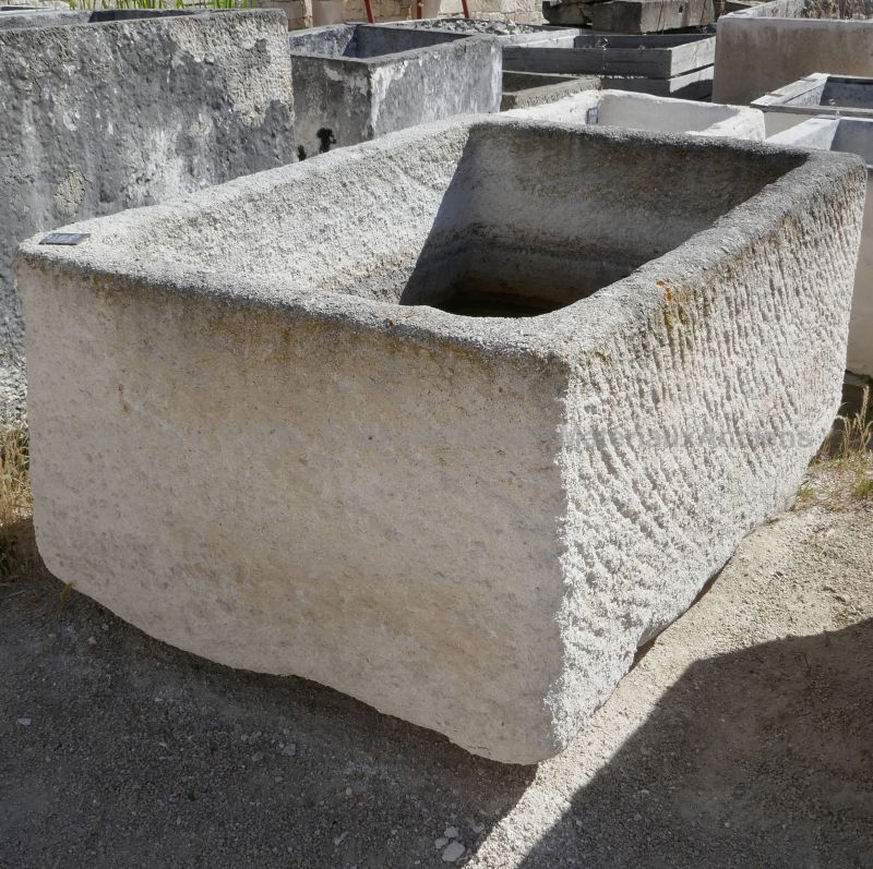 White rectangular stone trough : a wide and deep stone basin.