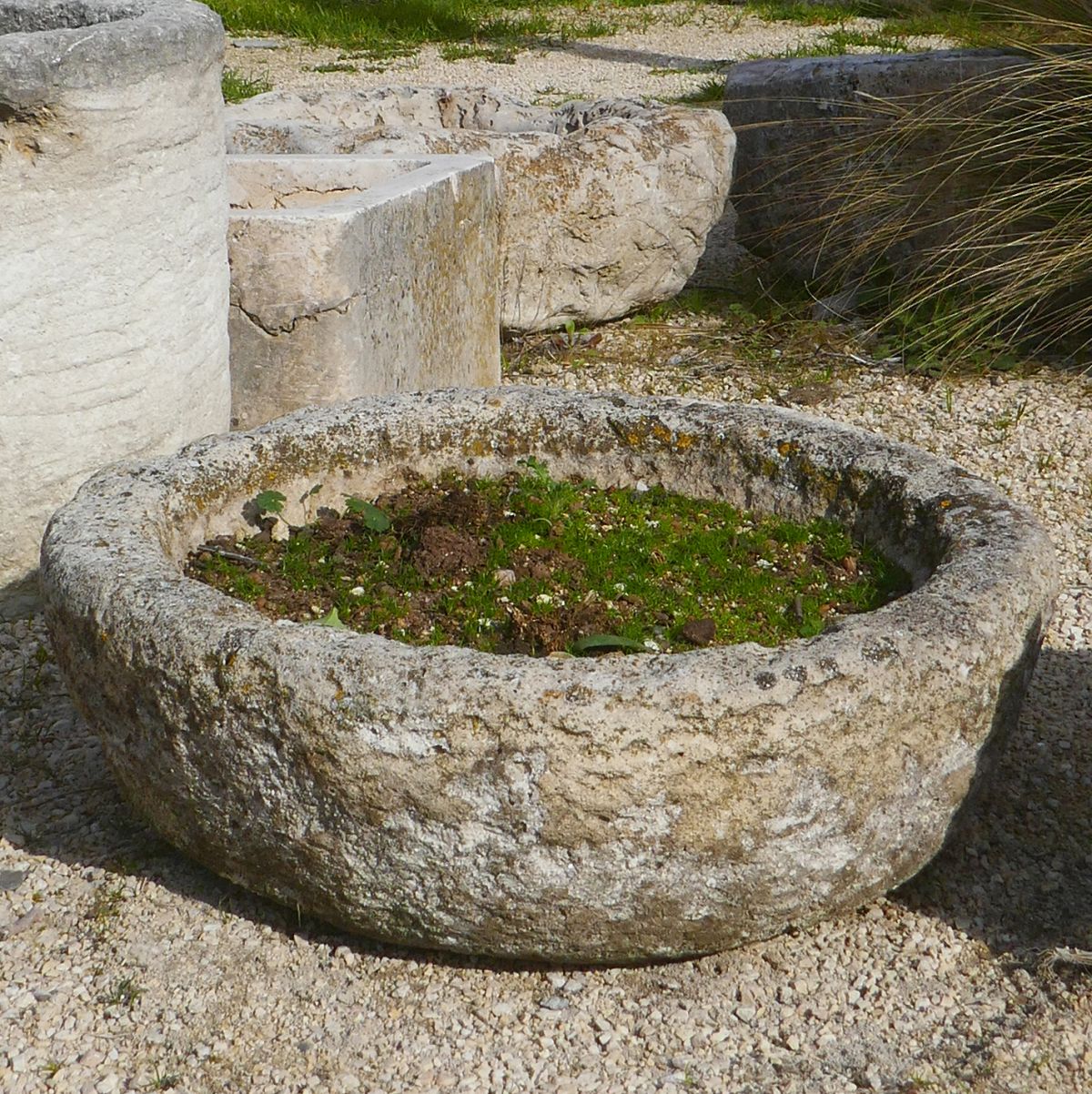 Antique round stone trough as an ecological and sturdy planter
