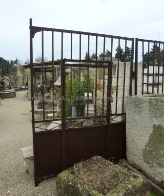 Wide antique wrought-iron gate with wicket-gate.