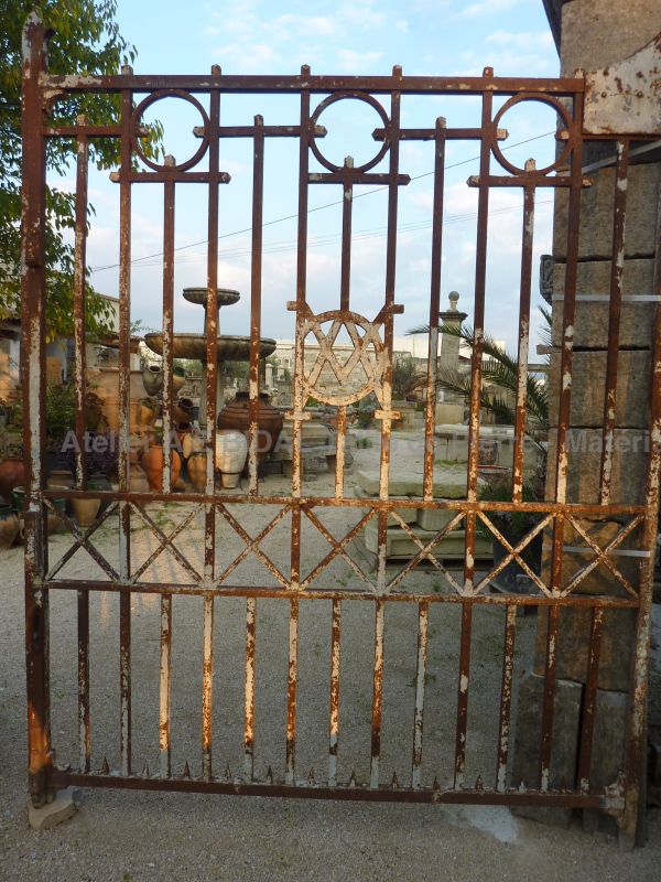 Old gate with a double gate an old gate made of iron, engraved with the ...