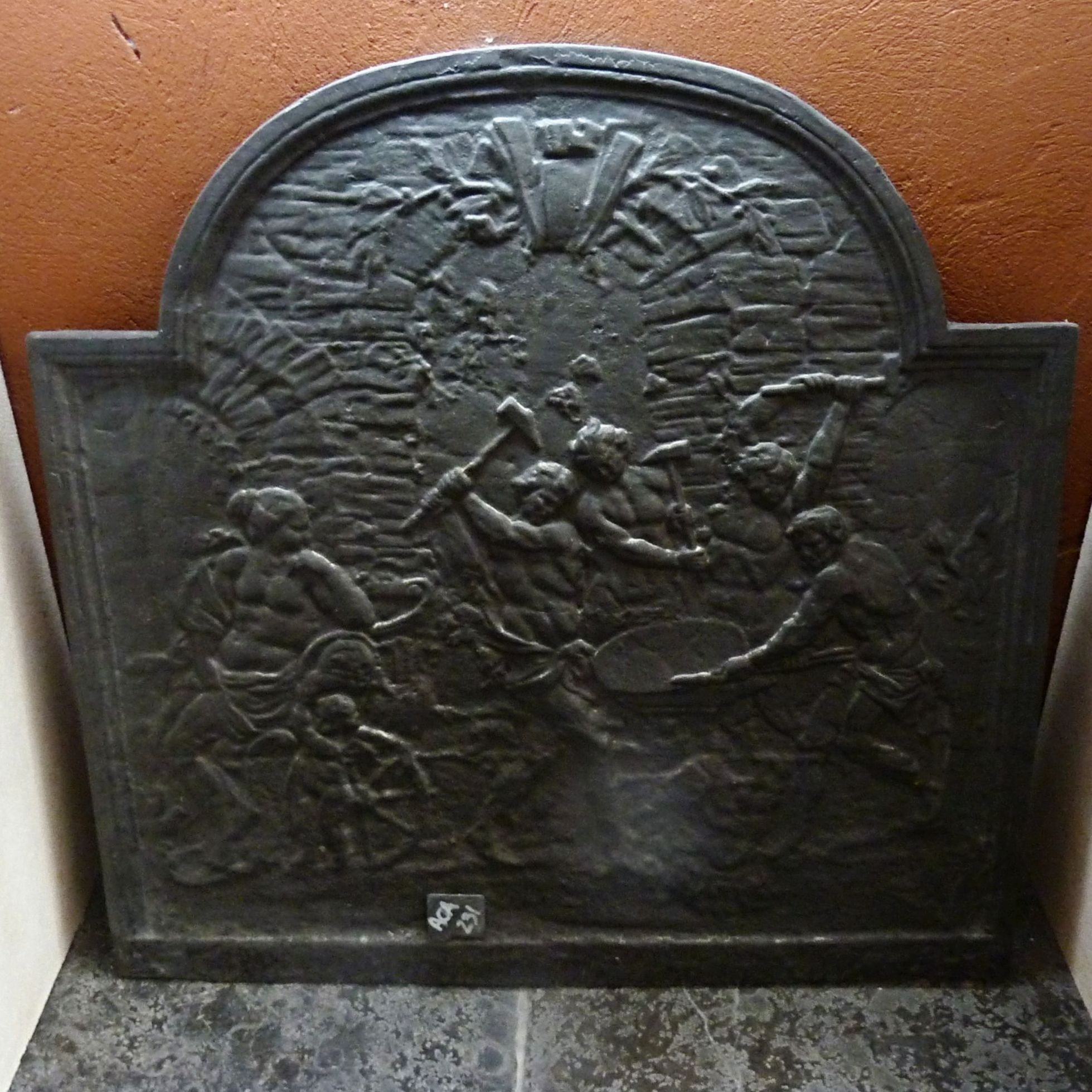 Antique cast iron fire back: Vulcan’s forge ** SOLD