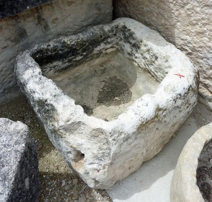 Small rustic stone basin / old basin made of natural stone.