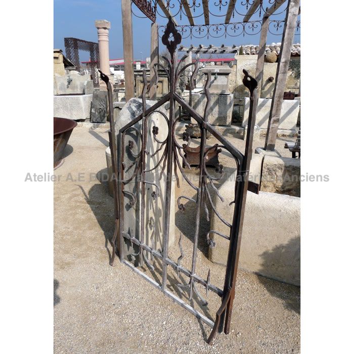 Old wrought iron gate with beautiful decorations and volutes.