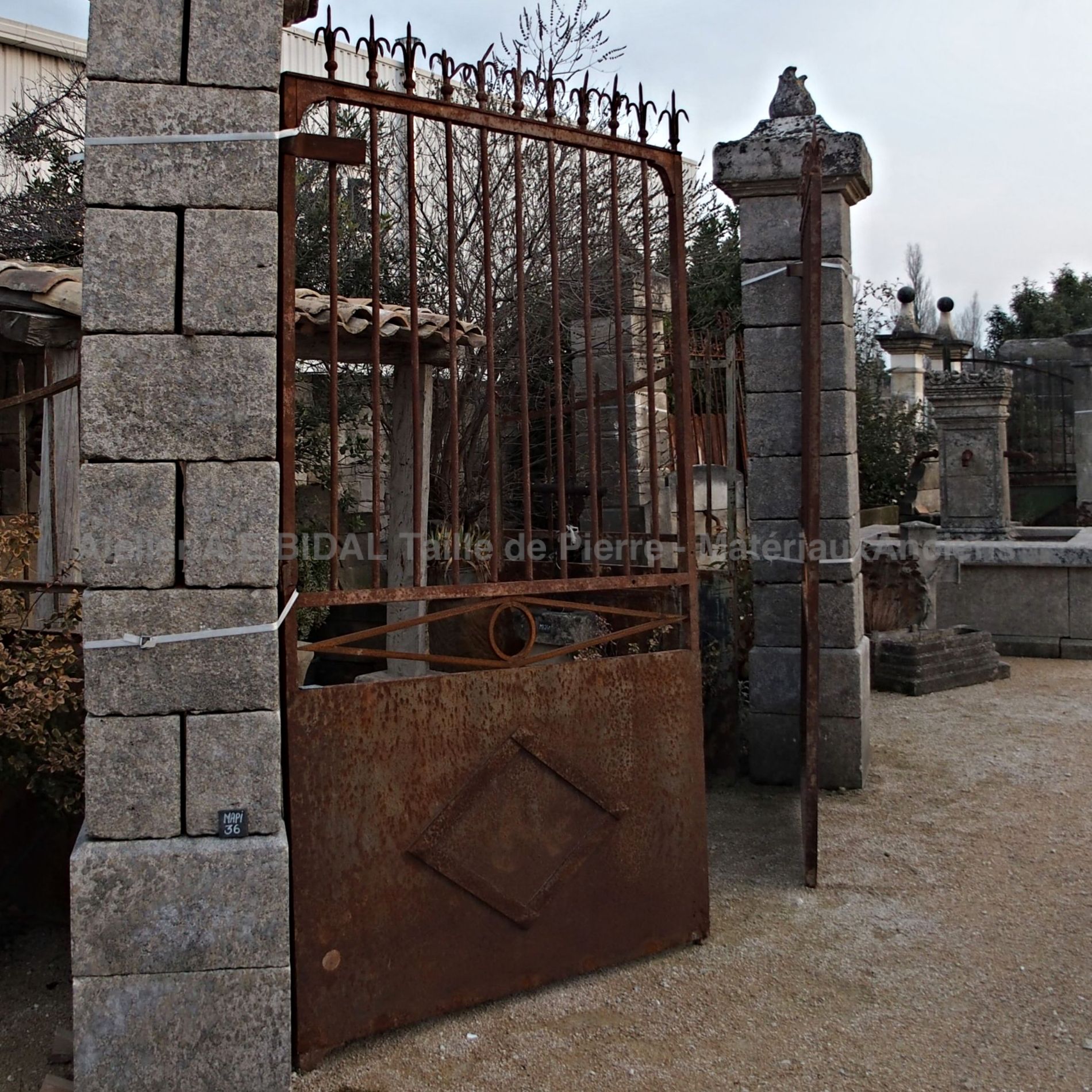Old wrought iron gate with its hinges - large wrought iron gate.