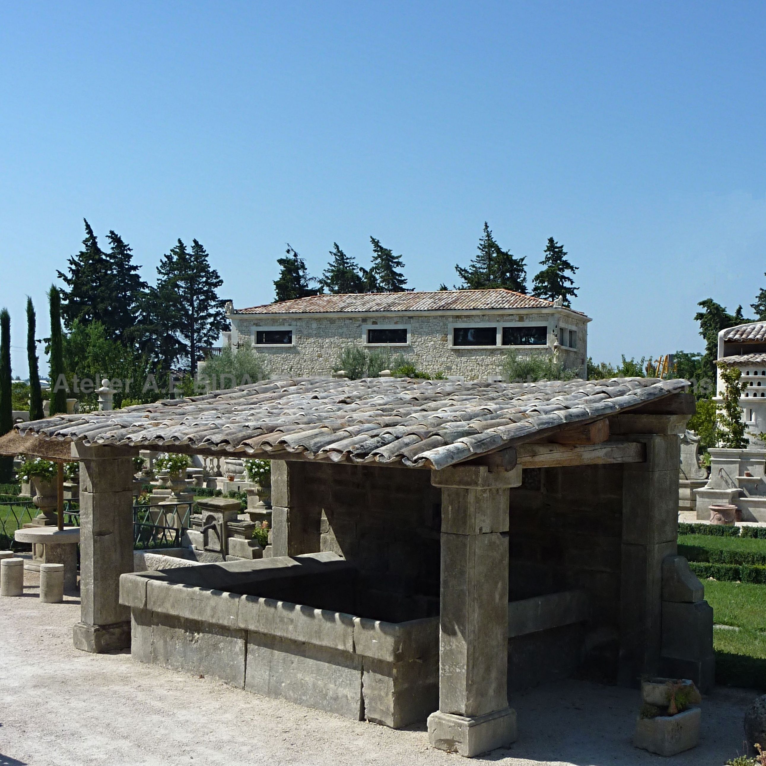 Old-fashioned village wash-house with old stone basin - stone garden ...