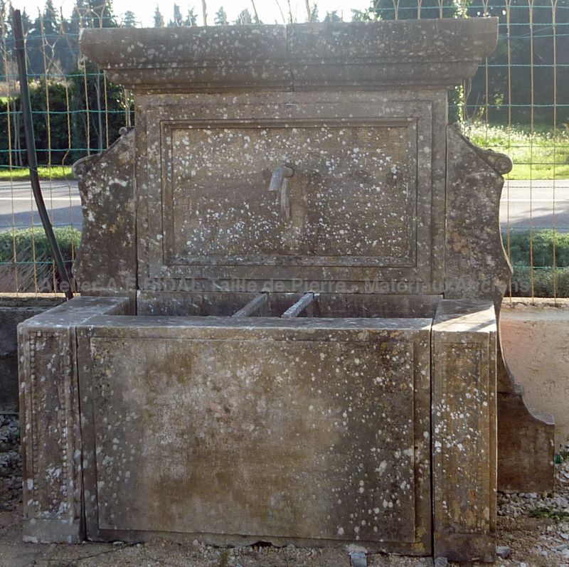Wall fountain - an outdoor fountain with rustic basin.
