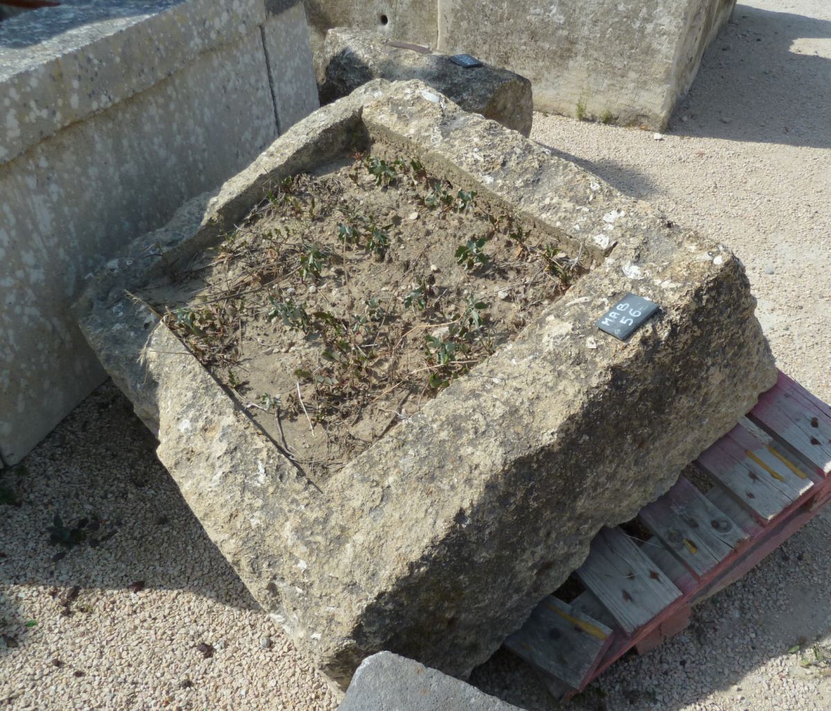 Small rounded stone bench, a creation by A Bidal, stonemason.