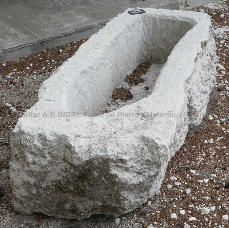 Rustic and rough-looking shallow stone trough for a beautiful planter