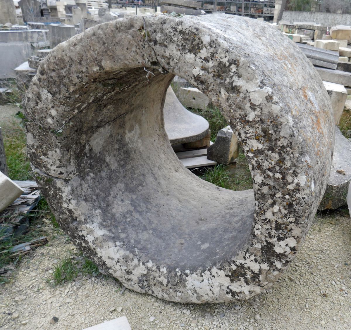 Large rustic well in aged and patinated stone for outdoor decoration