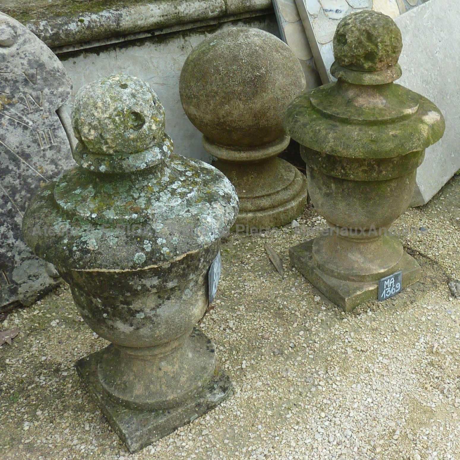 Pair of antique stone finials with patina