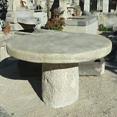 Ancient massive round table in massive stone for outdoor use