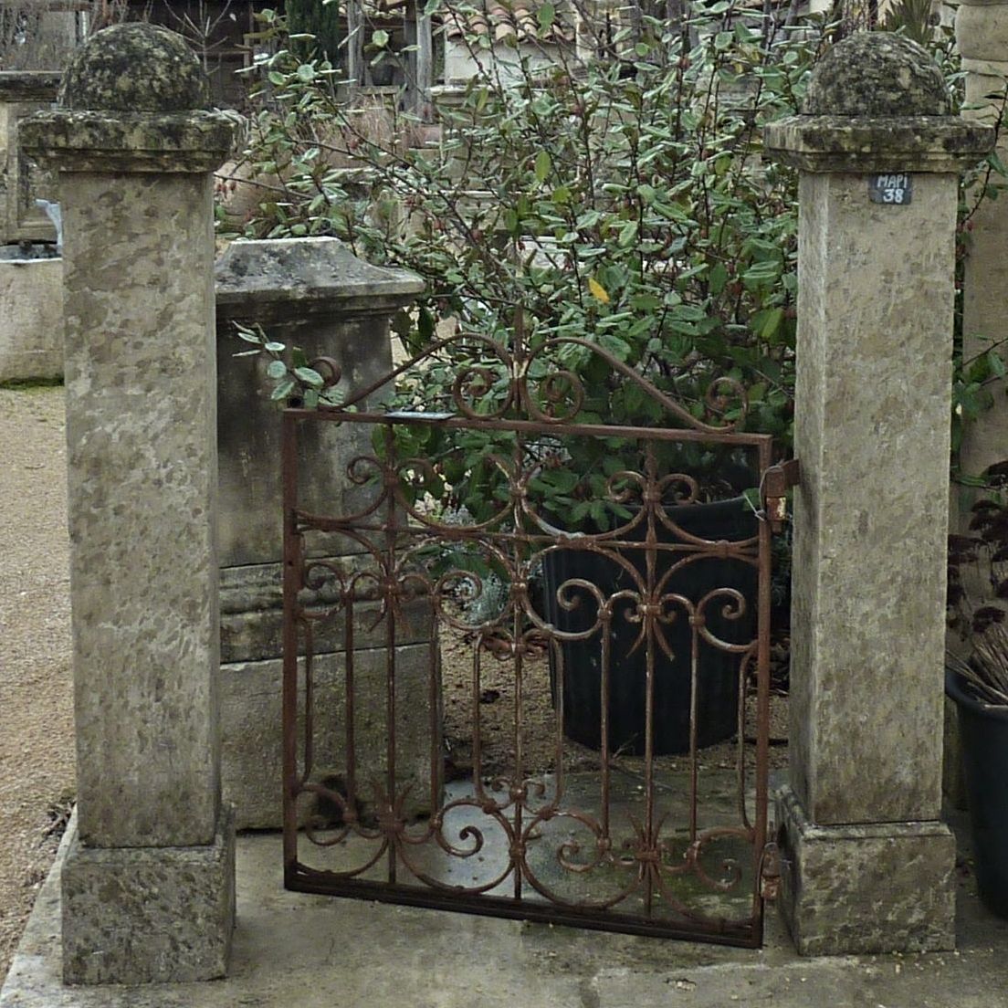 Antique pillar- a weathered stone pillar of rectangular shape.