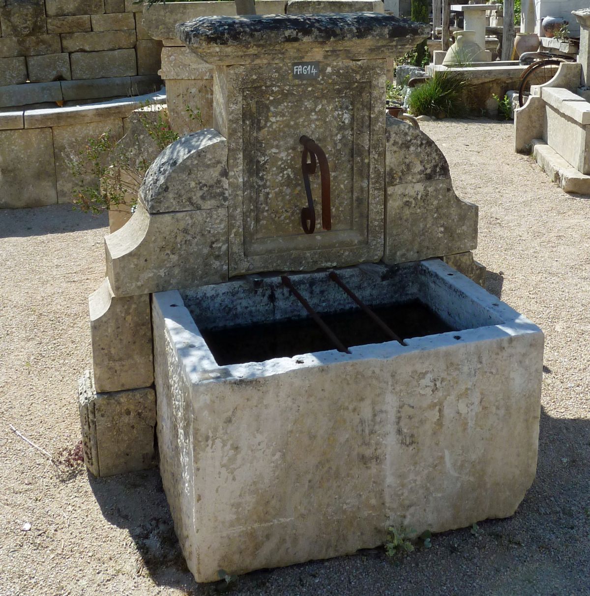 Outdoor fountain with basin, a wall fountain with a massive basin.