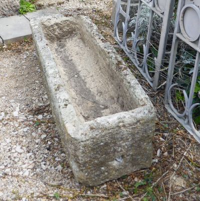 Old stone trough : a long and shallow rustic-looking planter