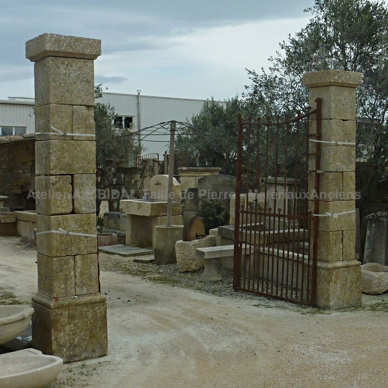 Sober and rustic pair of ancient stone pillars for main entrance