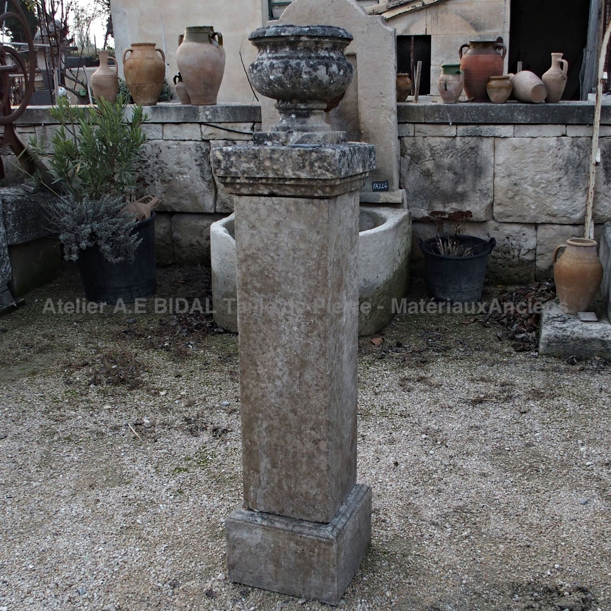 Antique stone pillars with urns