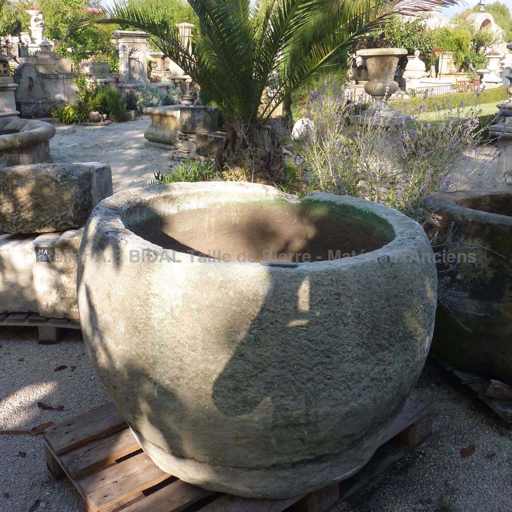 Garden fountain with natural stone sculpture of Bacchus.
