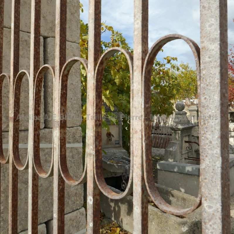 Fully open-worked old gate with 2 riveted wrought iron doors