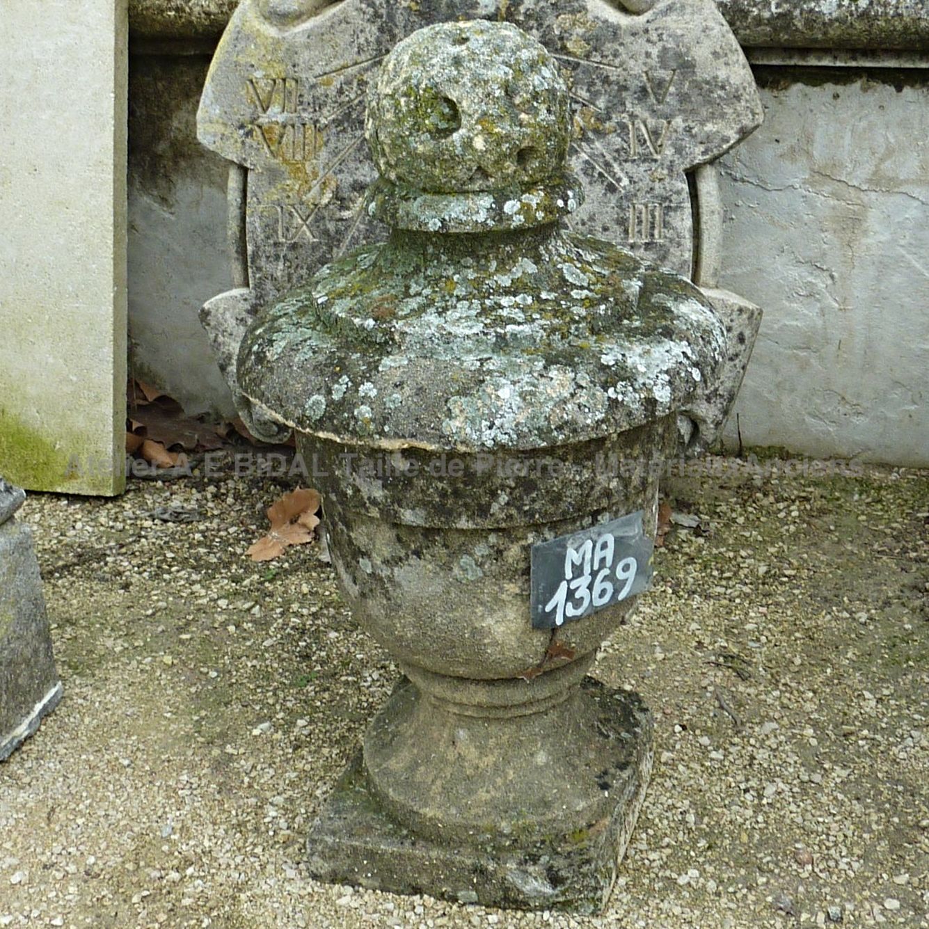Pair of antique stone finials with patina