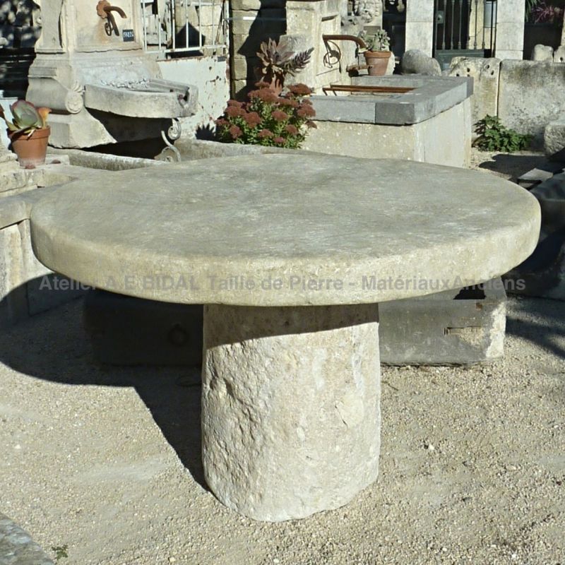 Ancient massive round table in massive stone for outdoor use