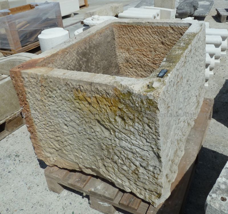 rectangular basin with a rustic style, a deep old stone basin.