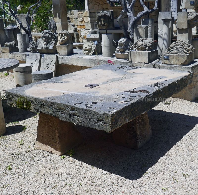 Rustic-looking garden table in weathered stones : garden furniture