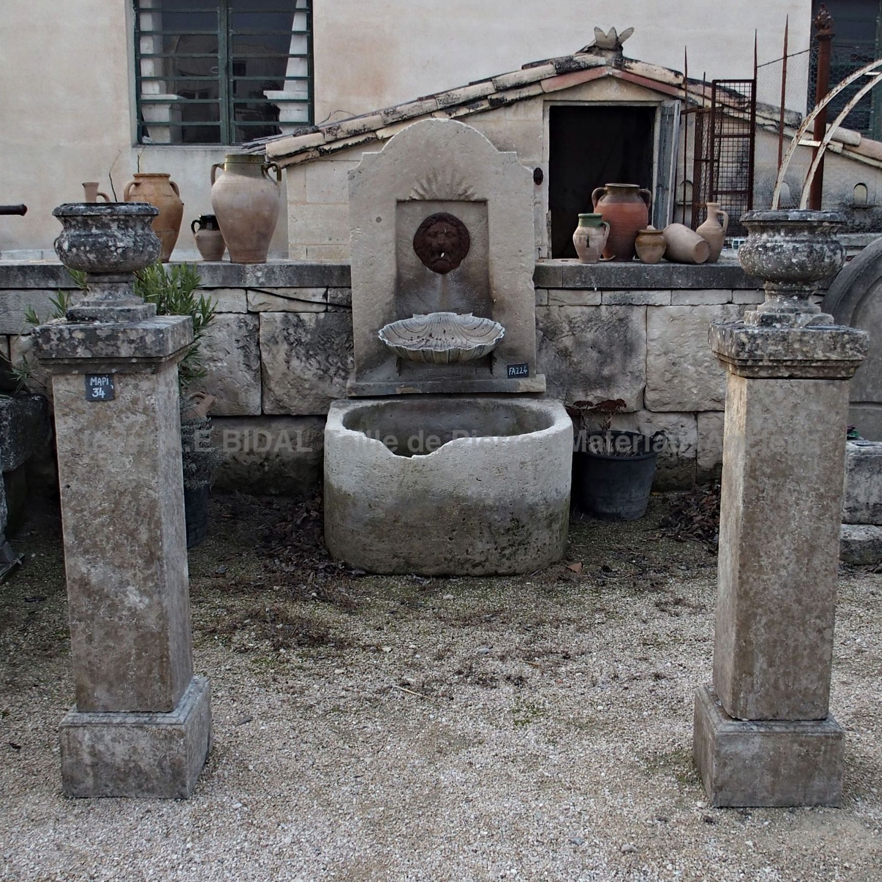 Antique stone pillars with urns